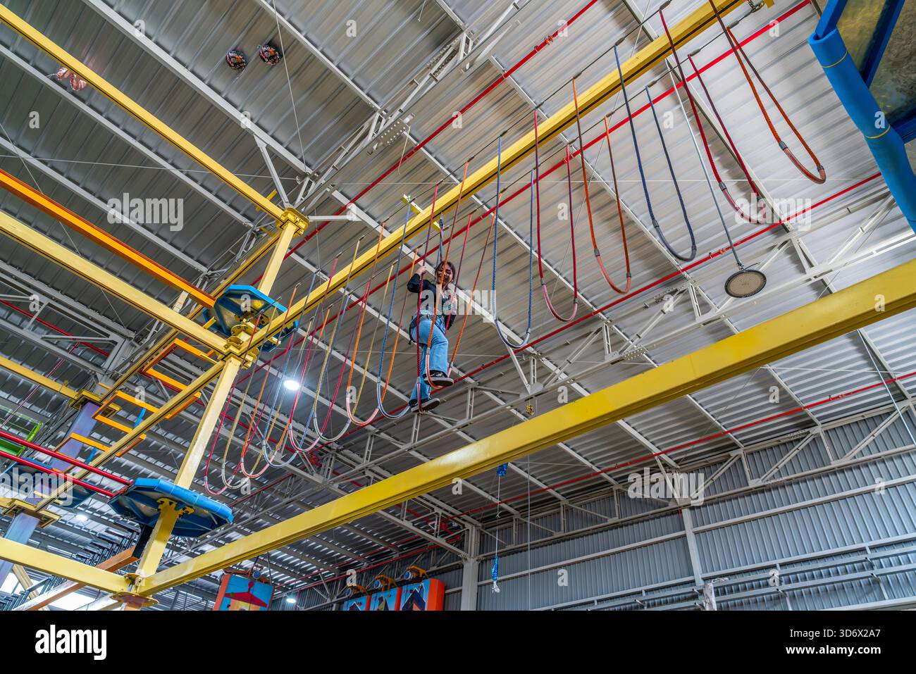 Documentary indoor aerial course showing a harnessed participant ...