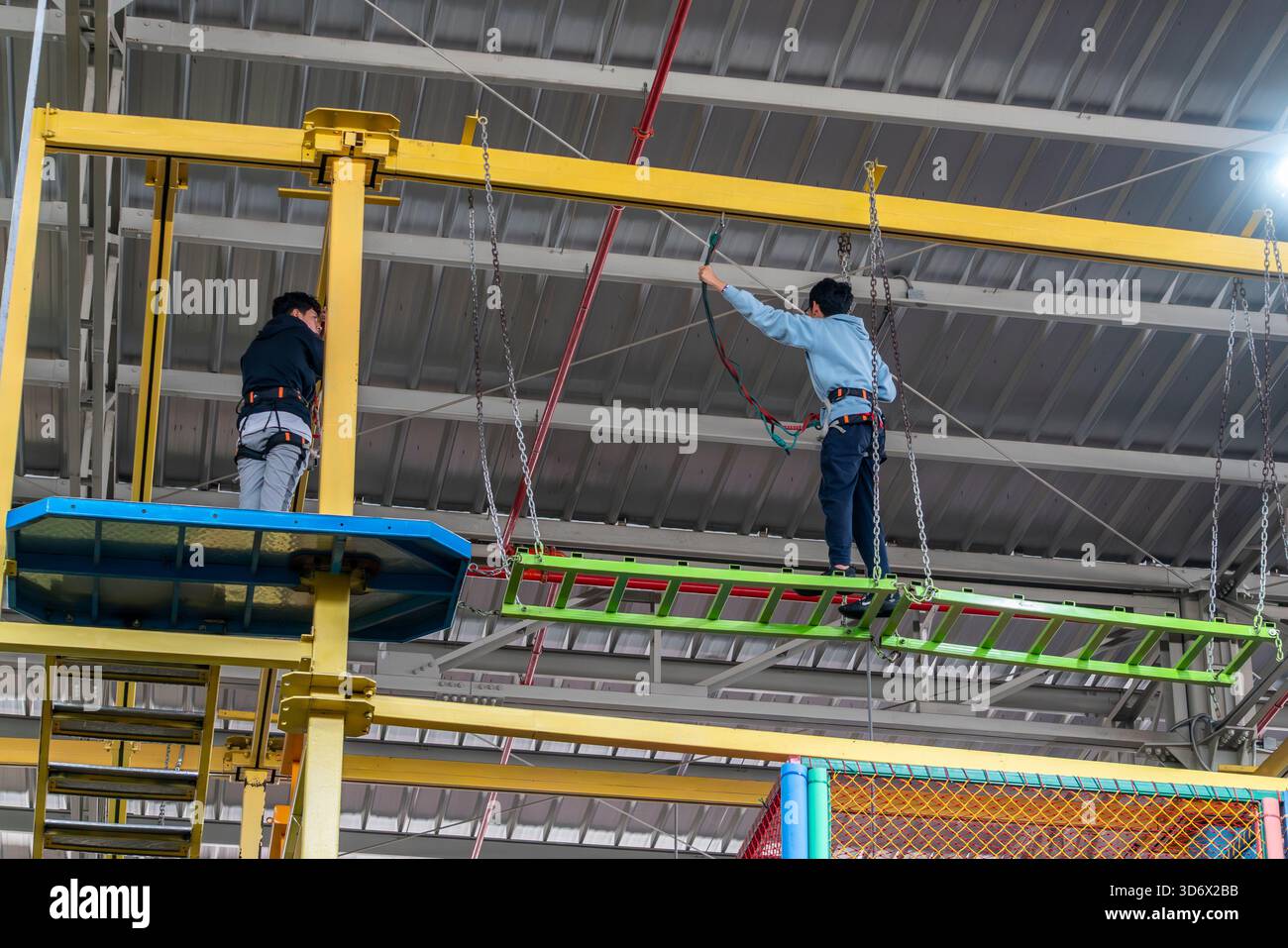 Documentary image of teens using harnesses while crossing an elevated ...