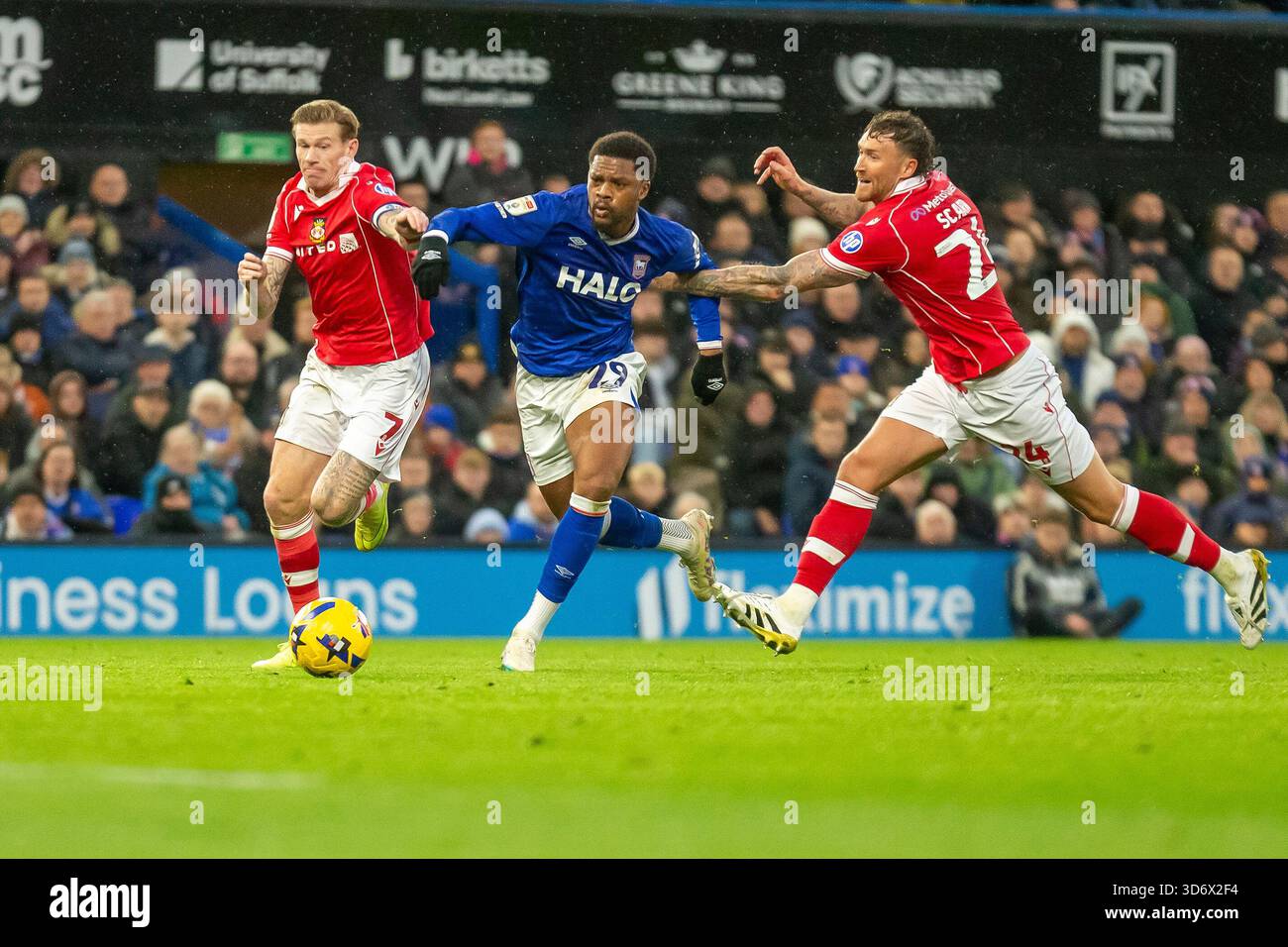 Chuba Akpom of Ipswich Town is brought down by Dan Scarr of Wrexham and ...