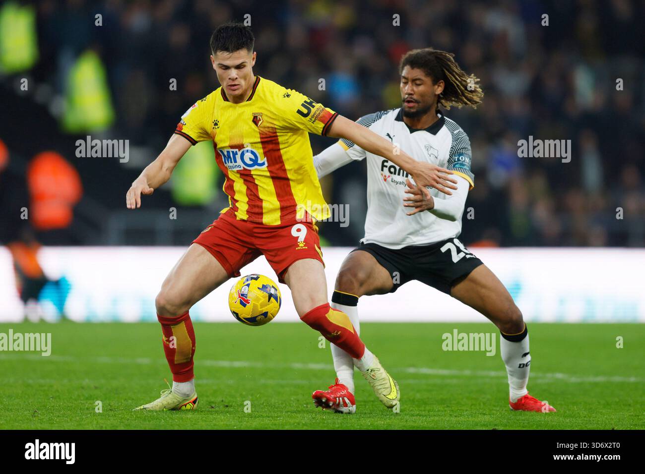 Watford's Luca Kjerrumgaard (left) and Derby County's Dion Sanderson ...