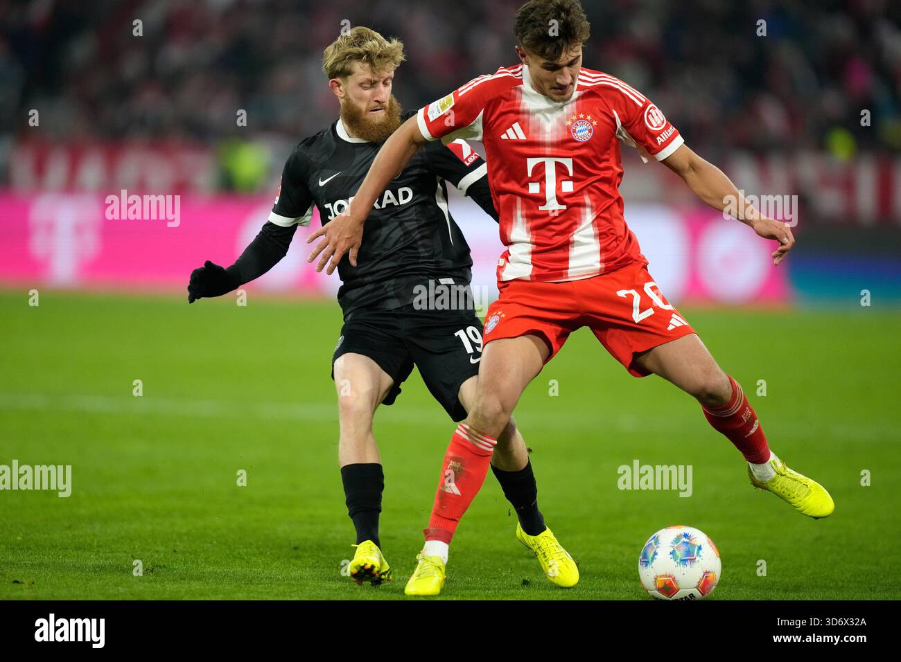 Freiburg's Jan-Niklas Beste, rear, and Bayern's Tom Bischof challenge ...