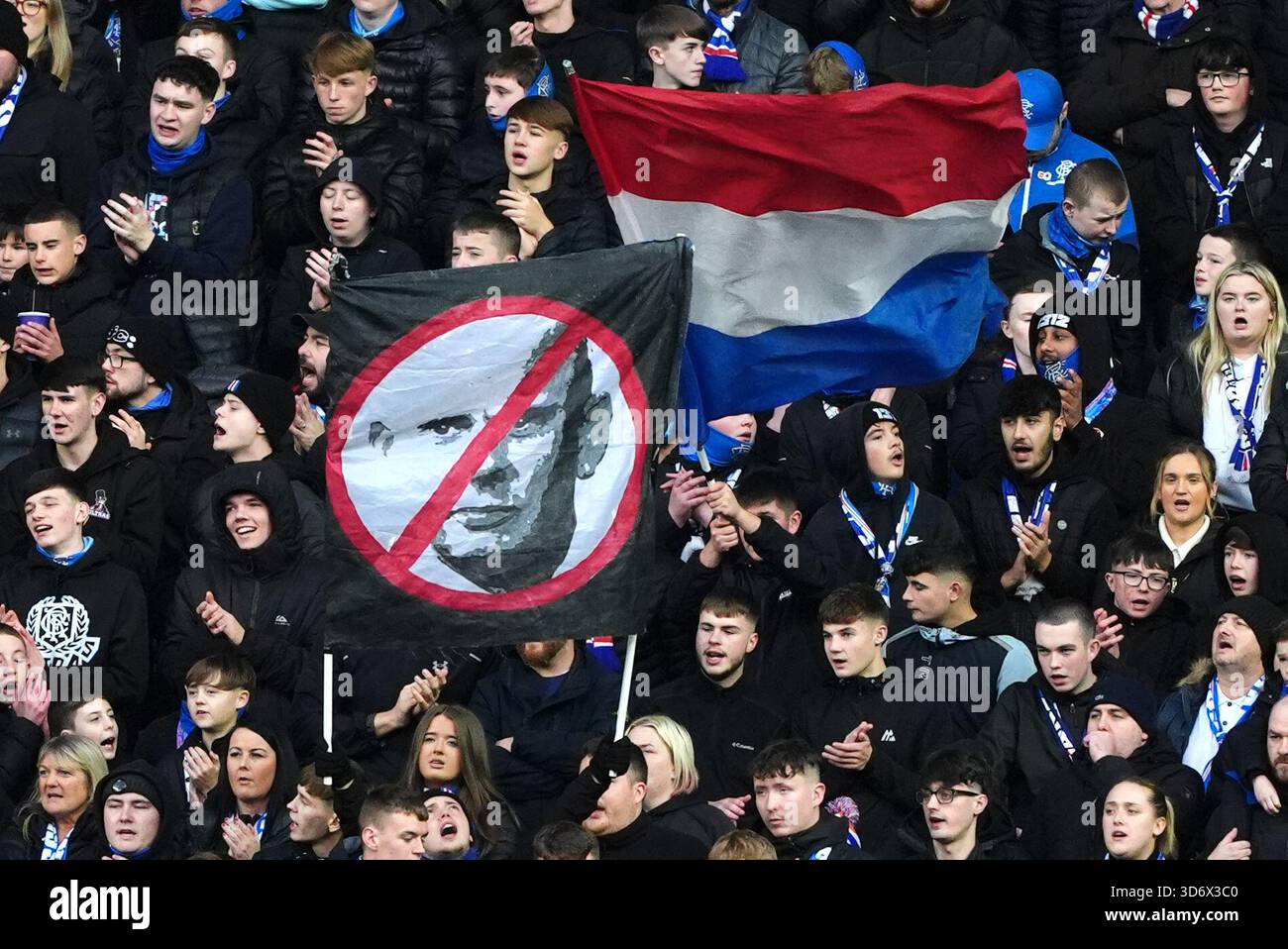 Rangers fans in the stands hold up banners with a picture of CEO ...