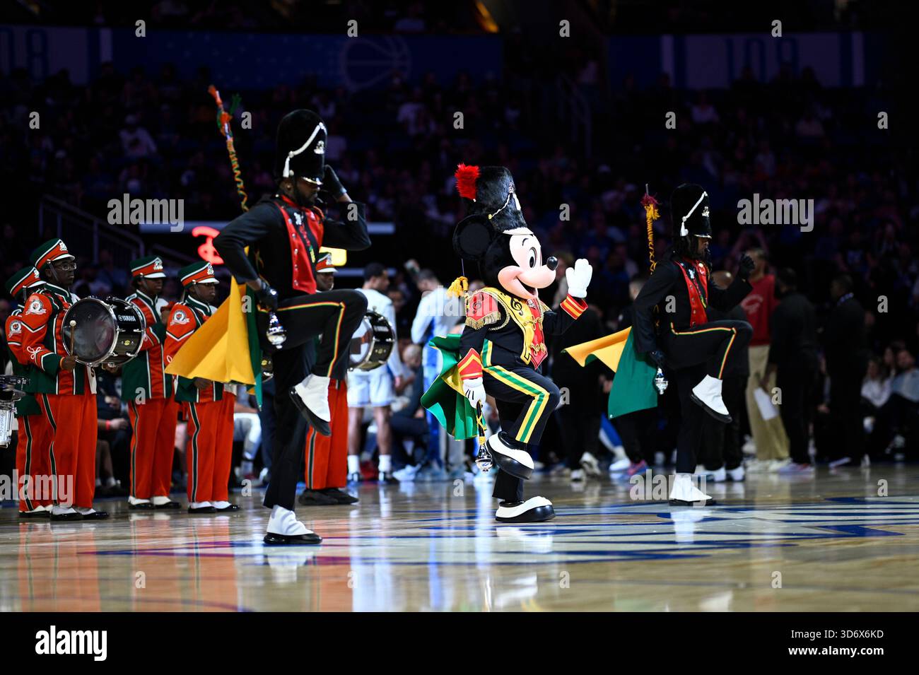 An actor dressed as Mickey Mouse performs with members of the Florida A ...