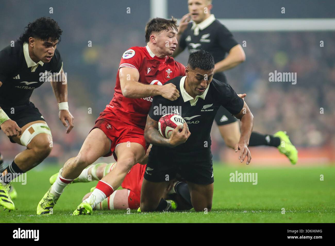 Rieko Ioane of New Zealand is tackled by Dan Edwards of Wales during ...