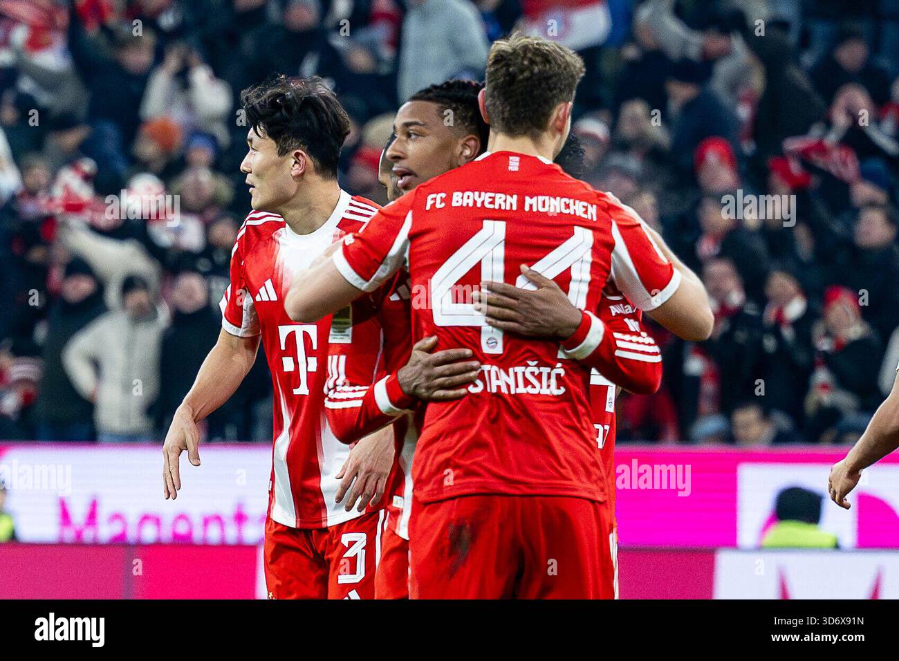Josip Stanisic (FC FC Bayern Munich, #44) is happy with Michael Olise ...