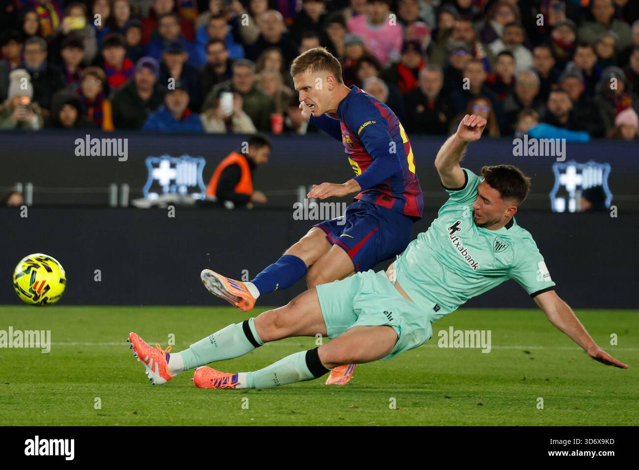 Barcelona's Dani Olmo shoots by Athletic Bilbao's Aymeric Laporte ...