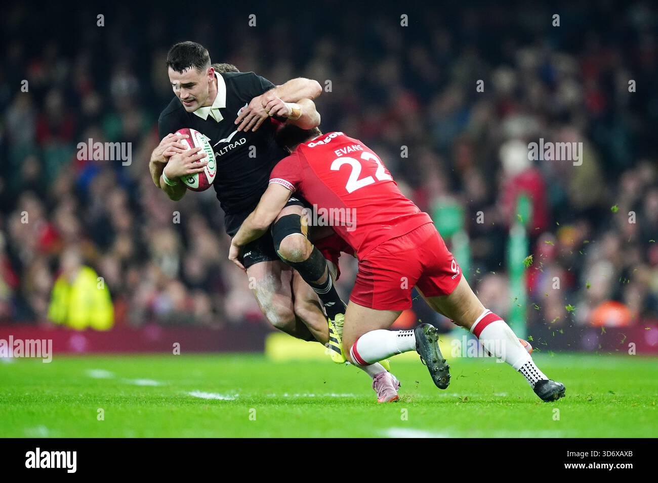 New Zealand's Will Jordan (left) is tackled by Wales' Jarrod Evans ...