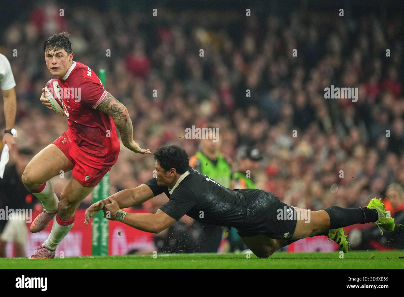 Wales' Louis Rees-Zammit gets past New Zealand's Caleb Clarke during ...