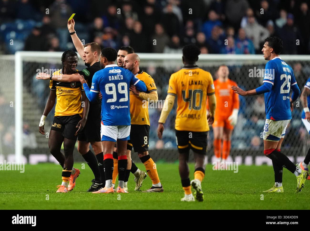 Referee Ross Hardie shows a yellow card to Livingston's Mahamadou ...