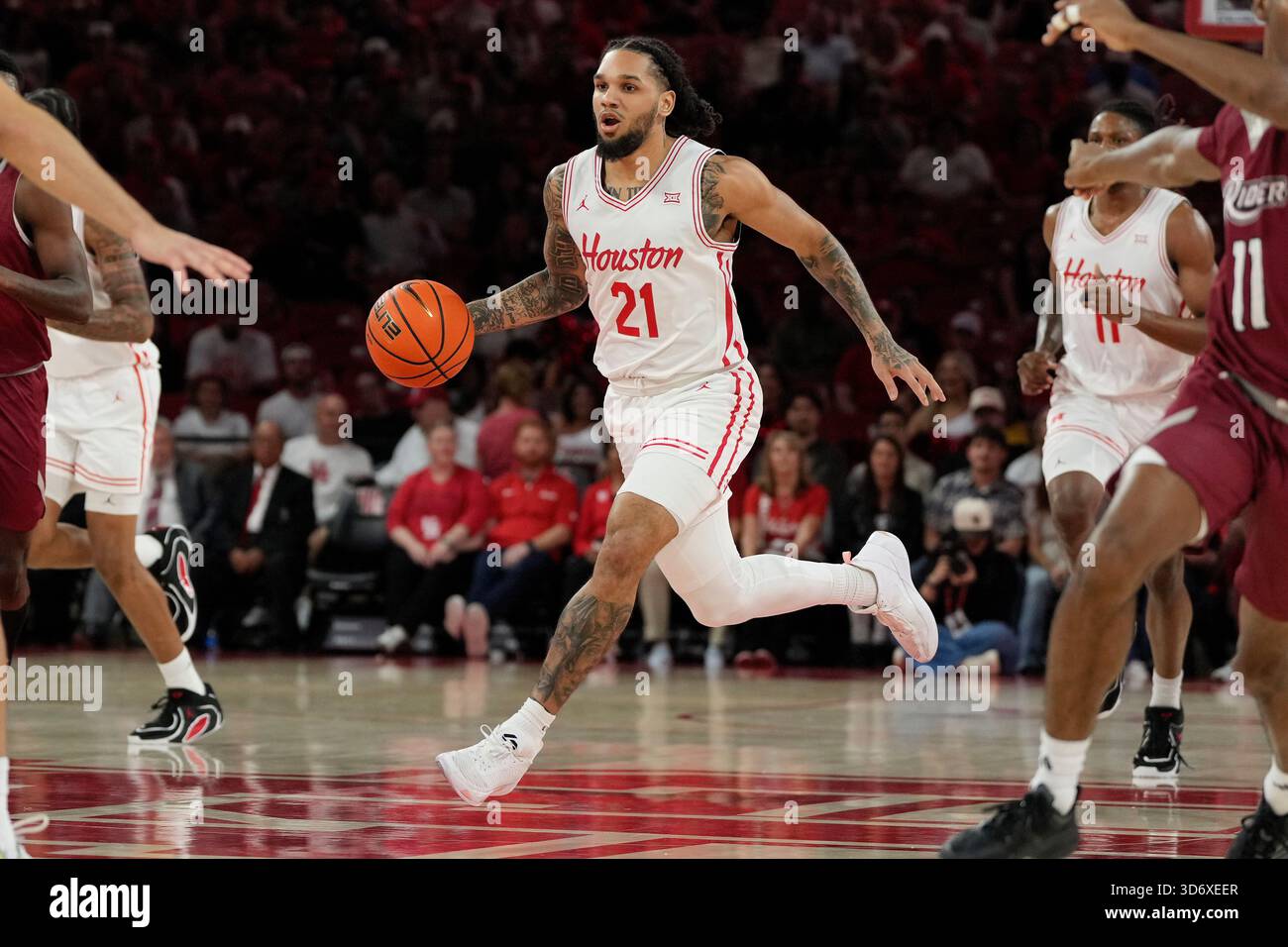 Houston guard Emanuel Sharp (21) brings the ball up during the first ...