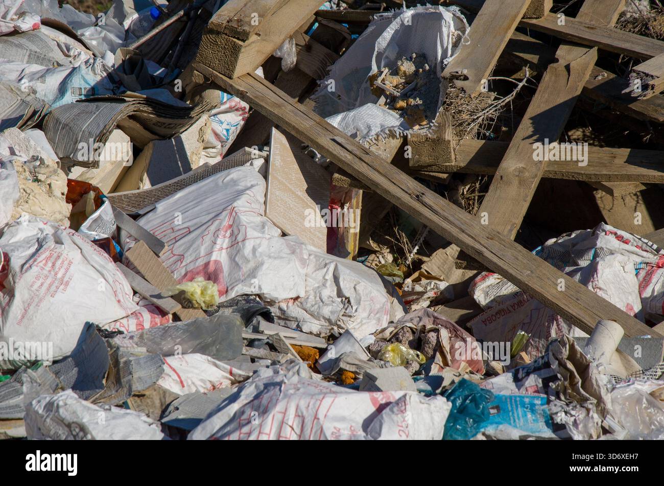Construction Debris Pile A heap of mixed waste, wood planks, and rubble ...