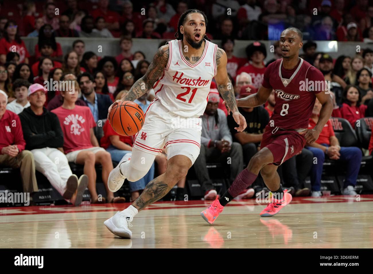 Houston guard Emanuel Sharp (21) drives past Rider guard Devean ...