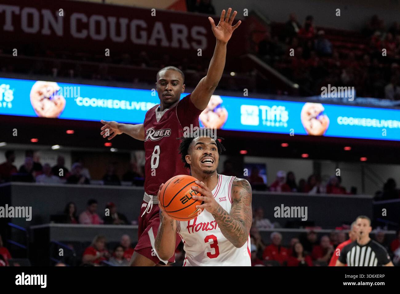 Houston guard Ramon Walker Jr. (3) drives past Rider guard Devean ...