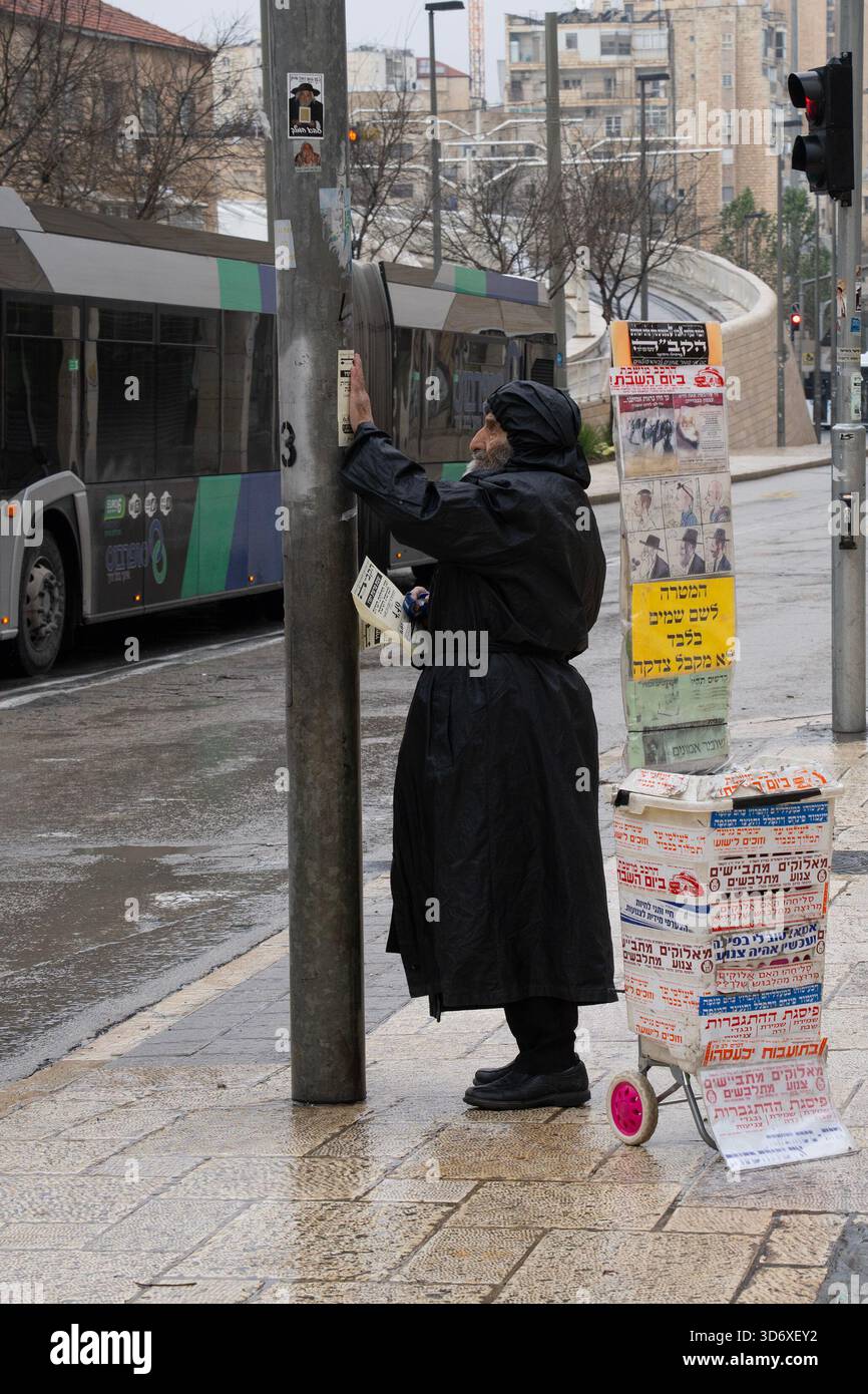 Jerusalem, Israel - February 10th, 2025:A Jewish orthodox man , posting ...