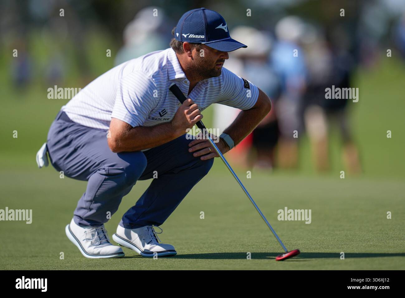 John Keefer lines up his putt on the first green during the third round ...