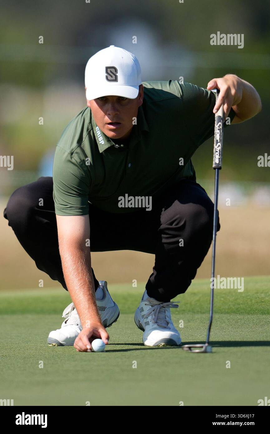 Sami Valimaki lines up a putt on the first green during the third round ...