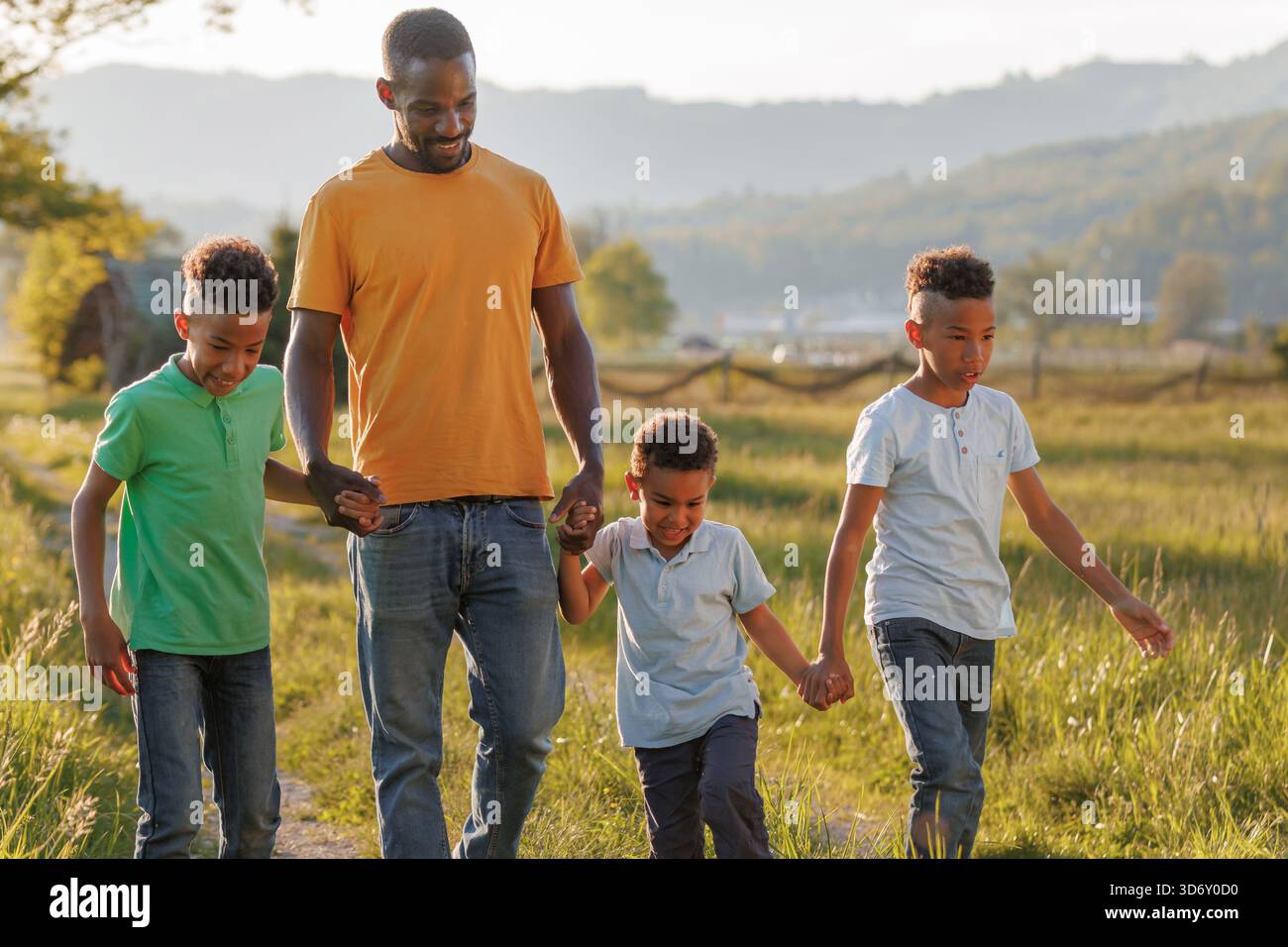 Children walking along path holding hi-res stock photography and images ...