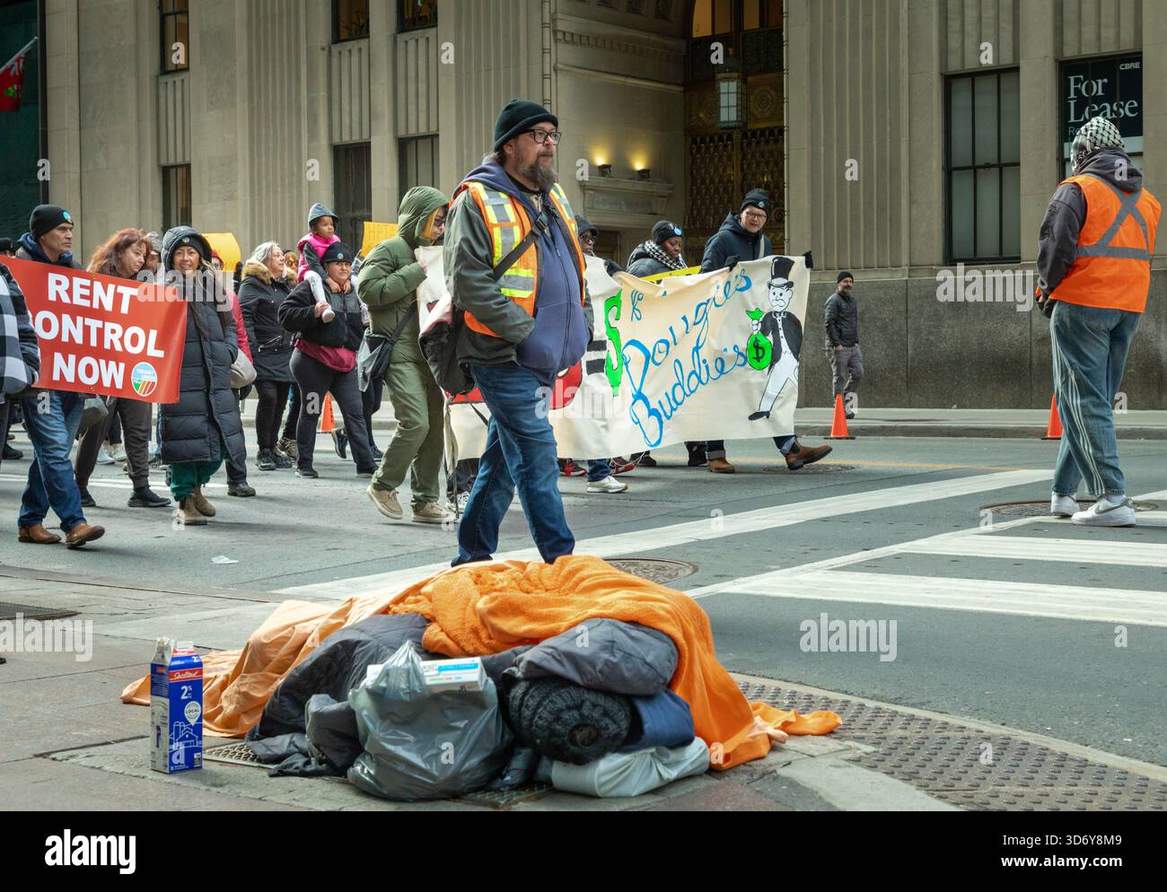 Toronto, Canada, 22nd Nov 2025. Tenant-rights activists march past a ...