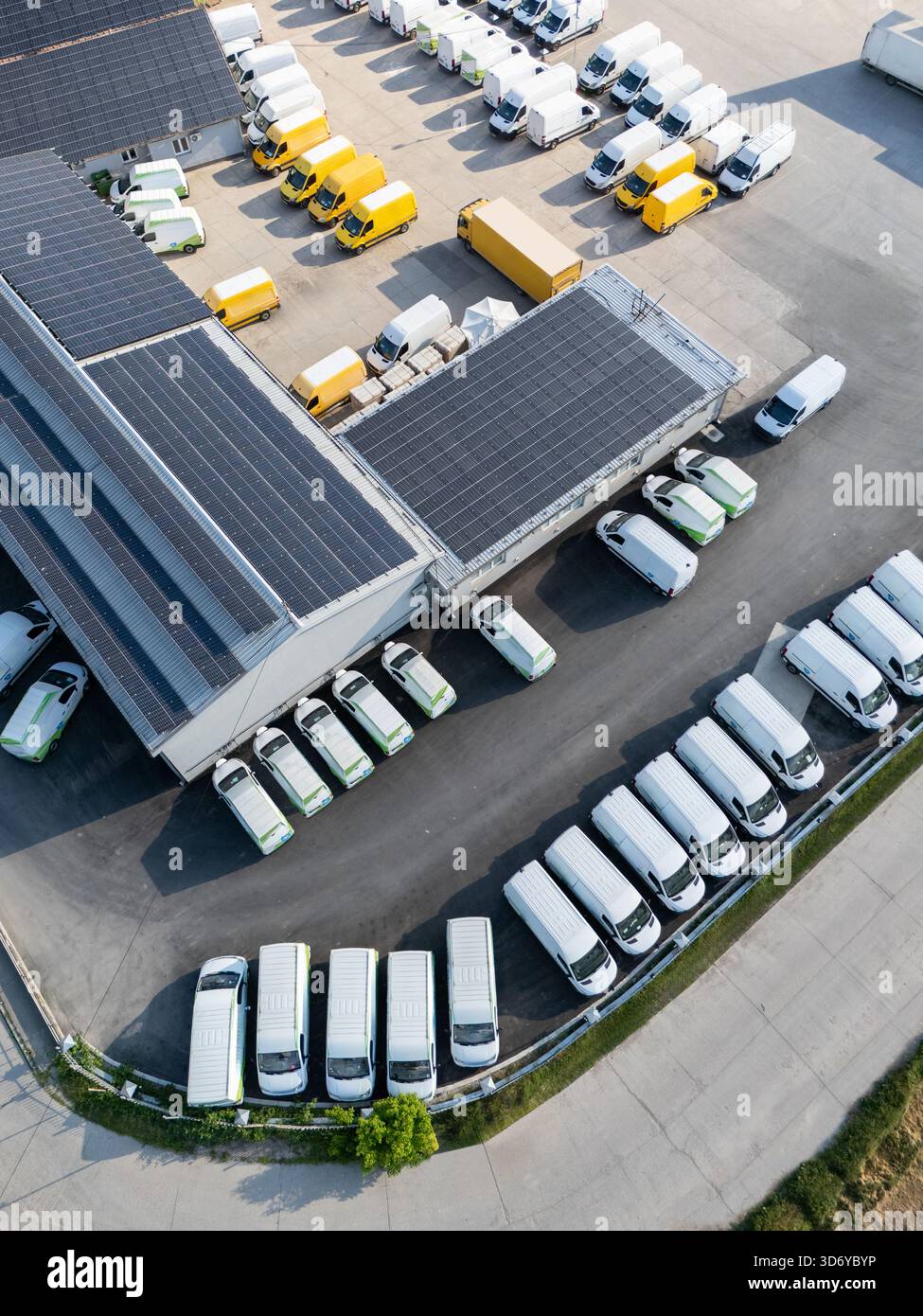 Electric delivery vans and trucks hub using renewable energy. Fleet of ...