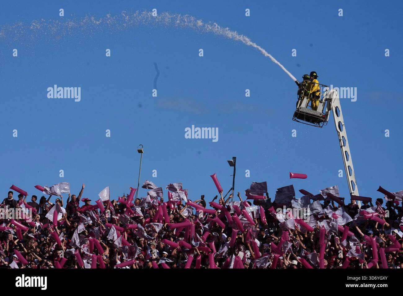 Firefighters spray water on fans of Argentina's Lanus during the Copa ...