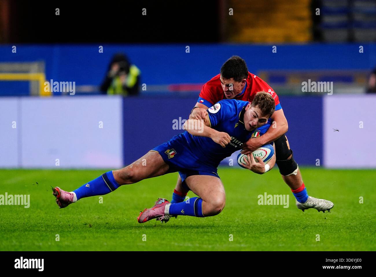 Italy's Leonardo Marin, front, is tackled by Chile's Augusto Boehme ...