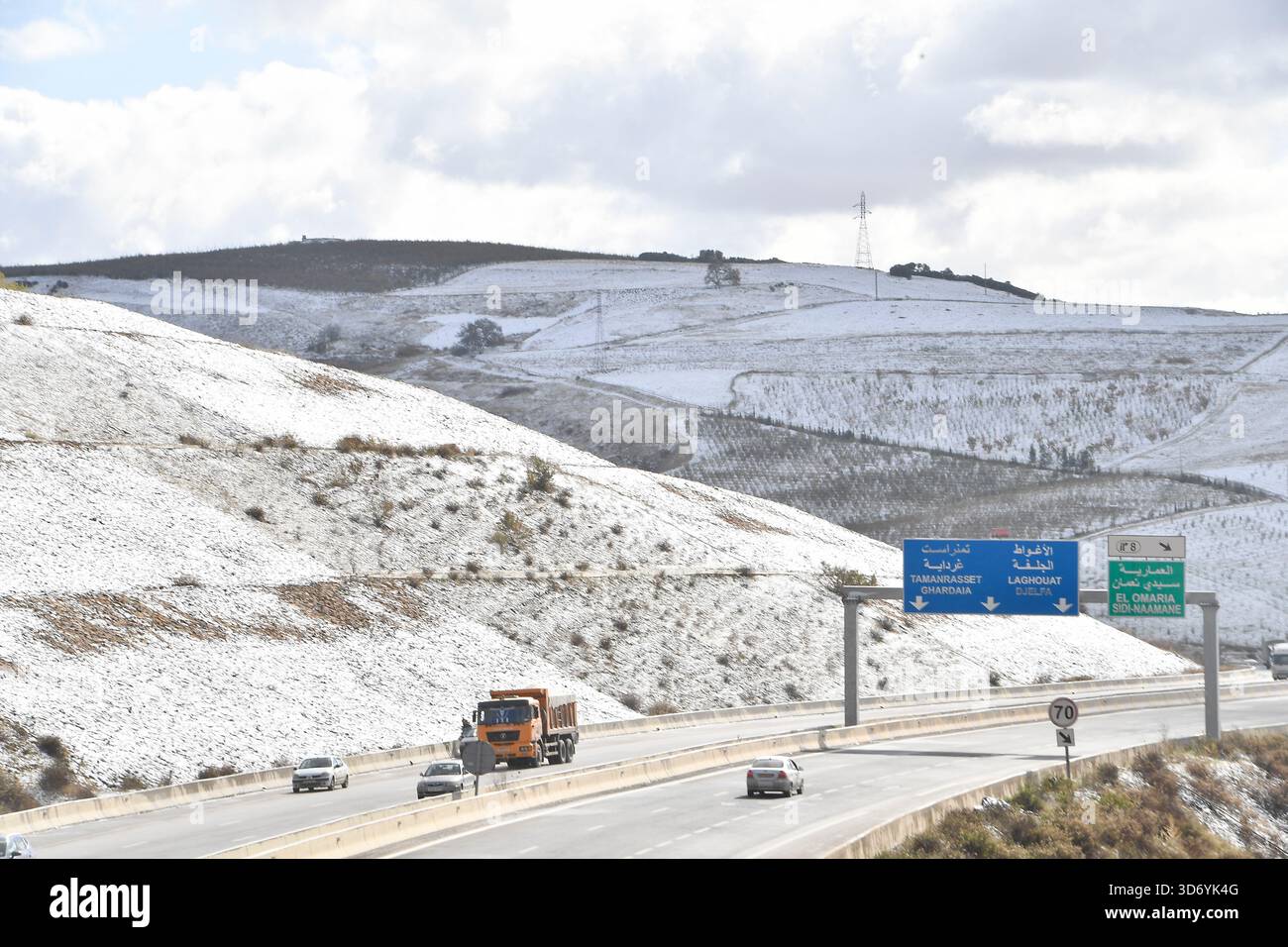 Cars drive past snow-covered mountains after extreme temperatures and ...