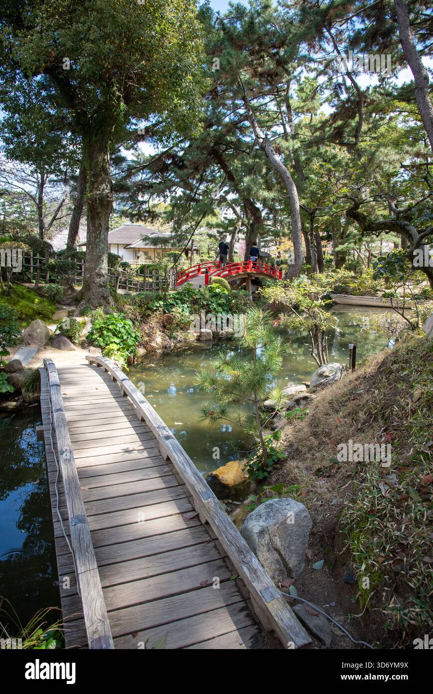 Wooden Garden Bridge Crossing Pond Toward Red Arch Bridge.A wooden ...