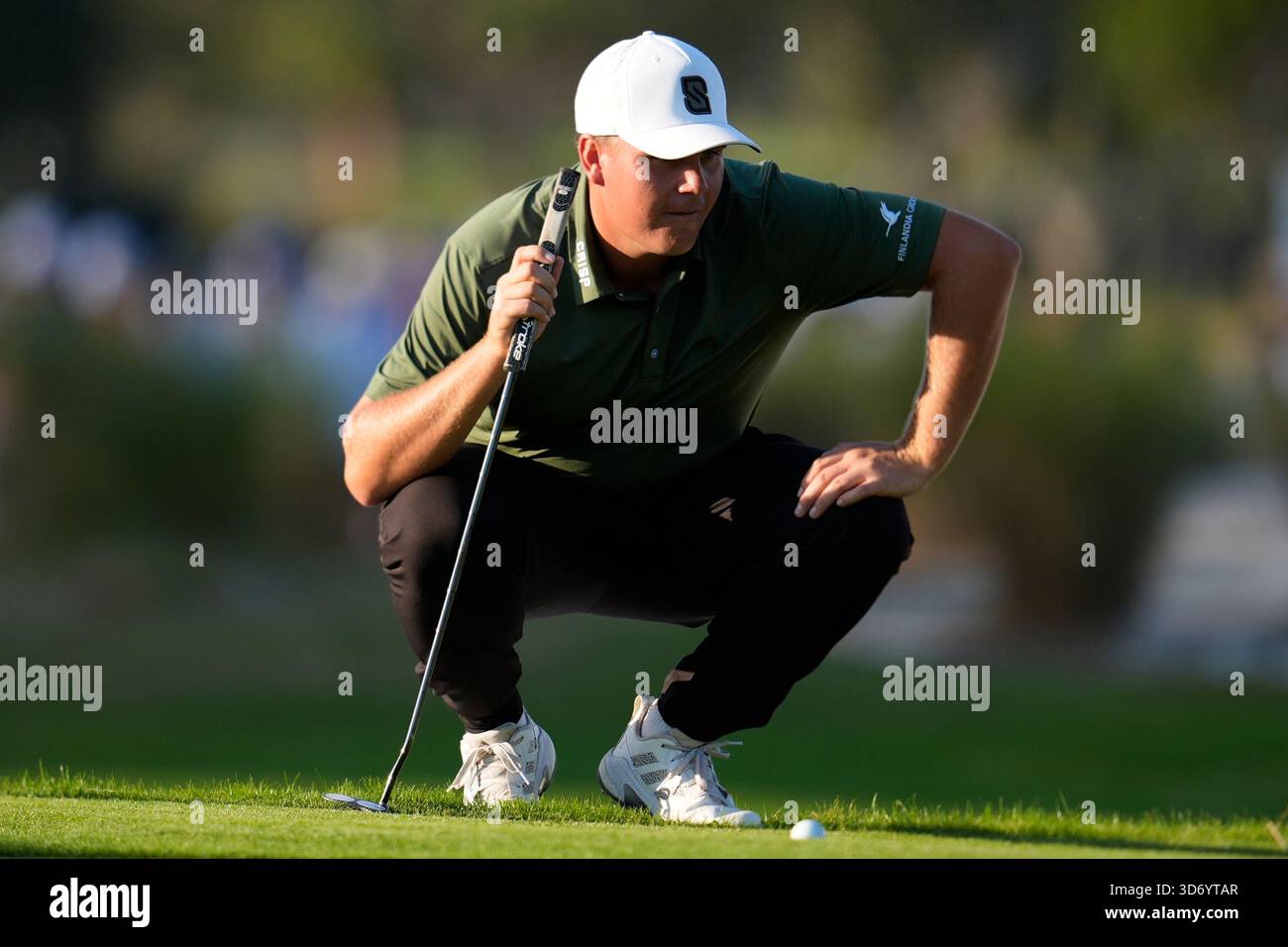 Sami Valimaki lines up his putt on the 18th green during the third ...