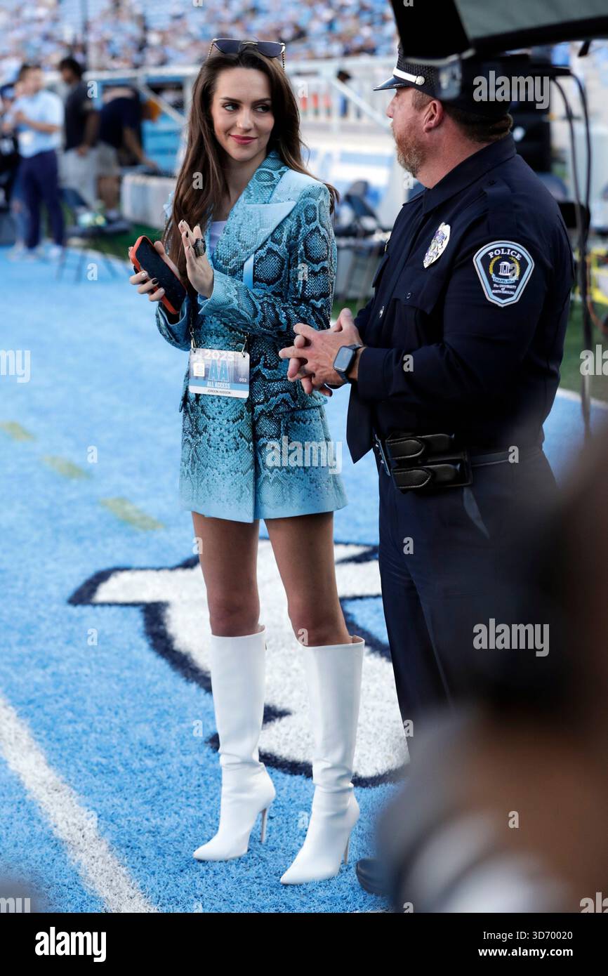 Jordon Hudson, left, stands on the sideline before an NCAA college ...