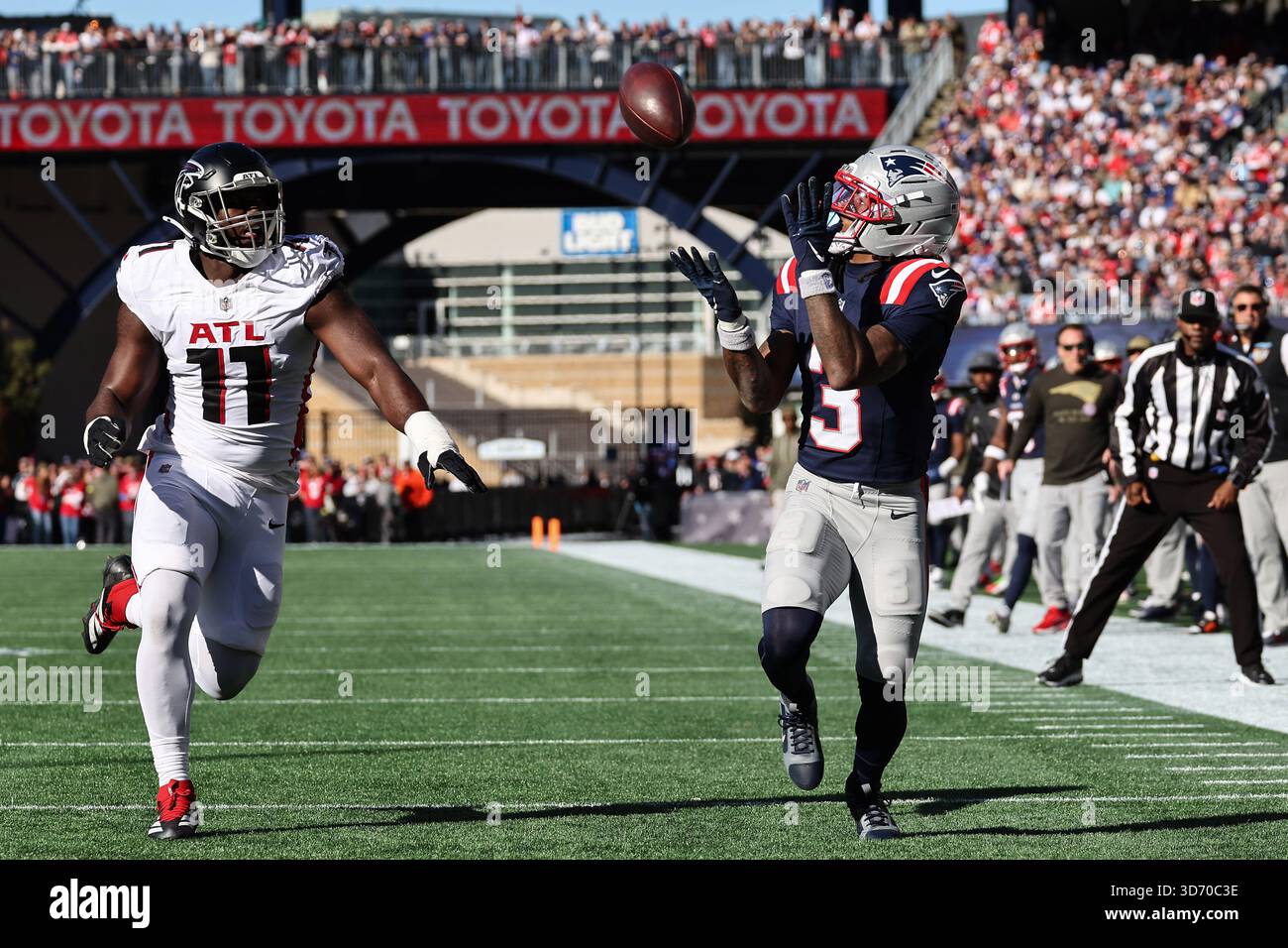 New England Patriots' DeMario Douglas catches a touchdown pass behins ...