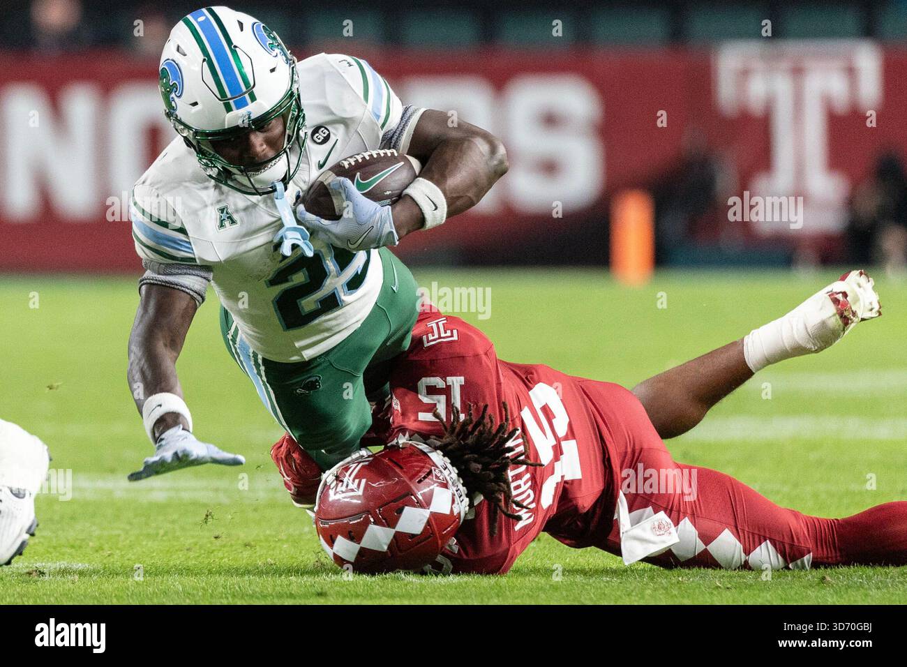 Tulane running back Jamauri McClure (25) is tackled by Temple safety ...