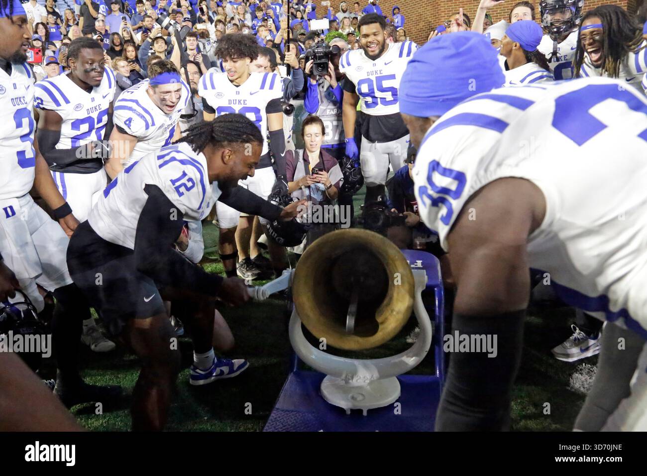 Duke players ring the Victory Bell after defeating North Carolina in an ...