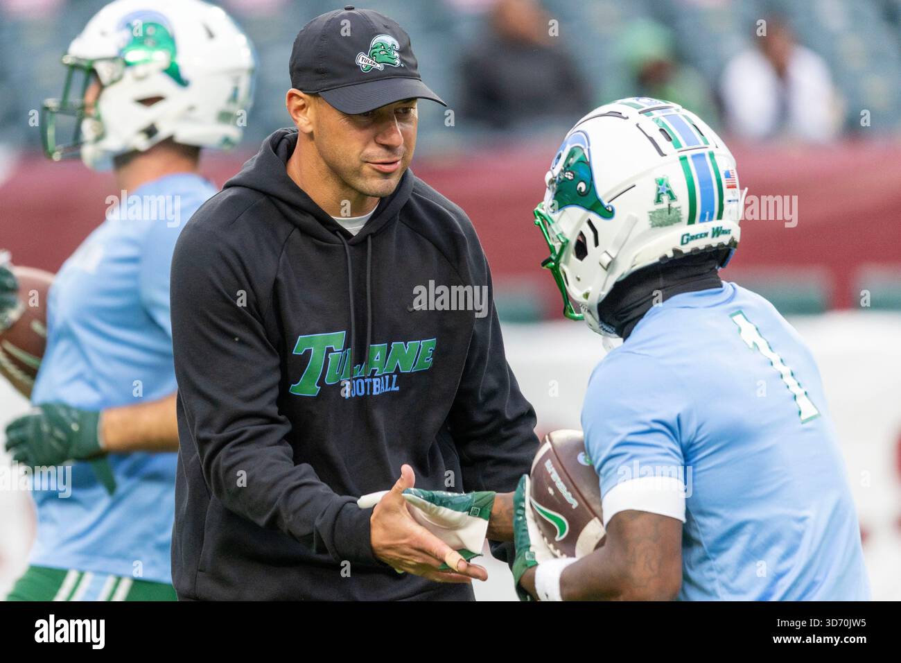 Tulane head coach Jon Sumrall, front left, talks to players before an ...