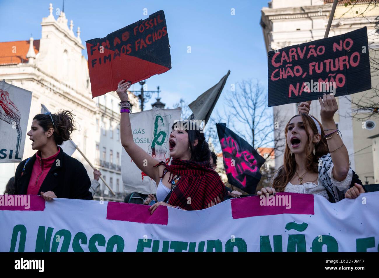 Activists chant slogans while holding placards during the demonstration ...