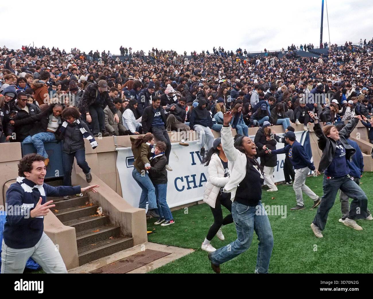 Yale fans pour onto the field after Yale beat Harvard in an NCAA ...