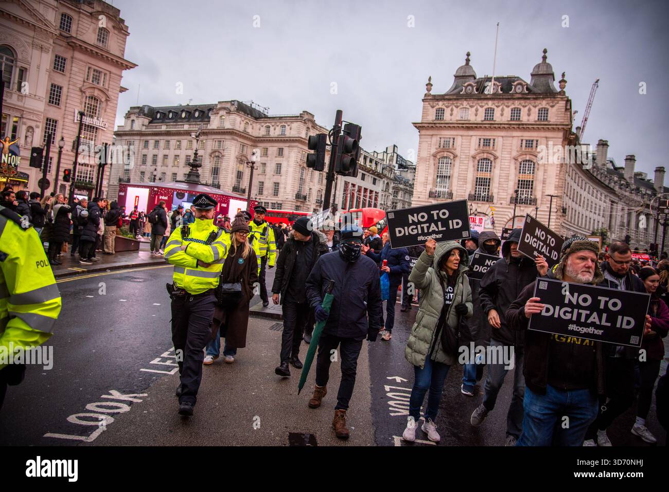 Protestors with placards march during the Unite Against Digital ID ...