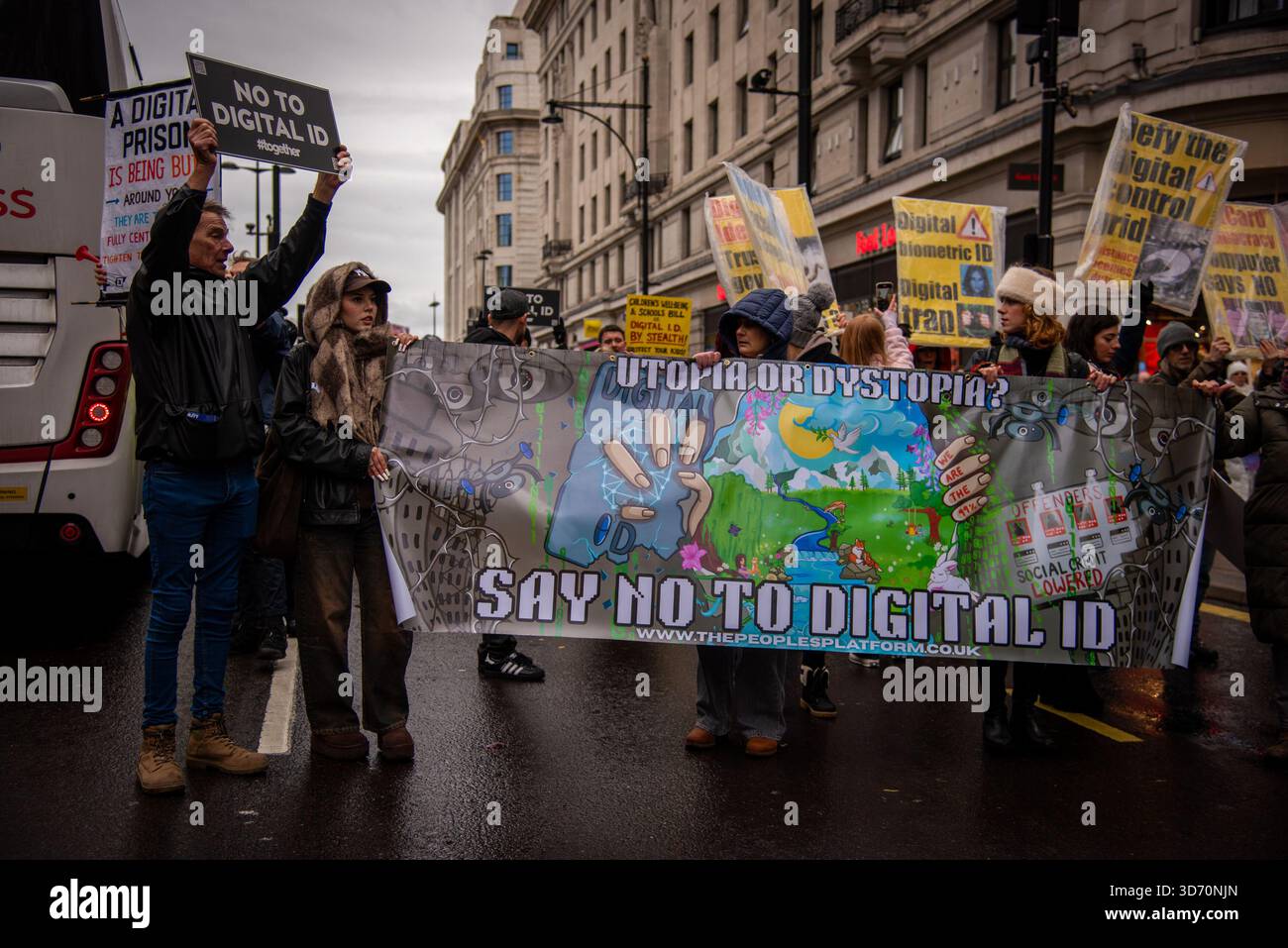 Protestors march with a large banner and placards during the Unite ...