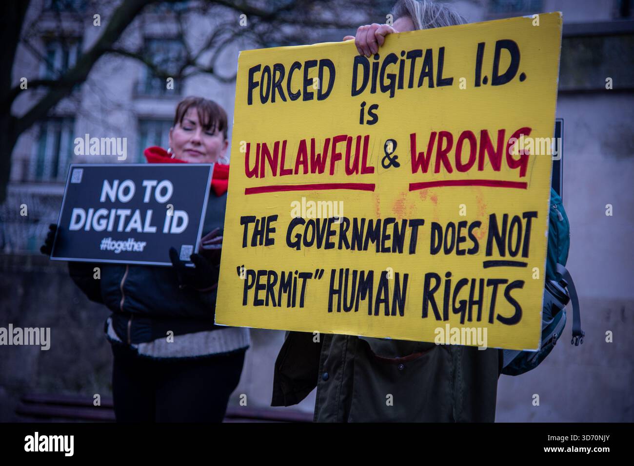 A protestor holds a placard during the Unite Against Digital ID Protest ...