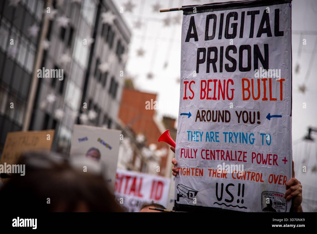 A protestor holds a placard during the Unite Against Digital ID Protest ...