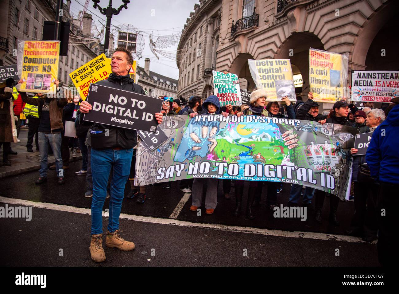 Protestors march with a large banner and placards during the Unite ...