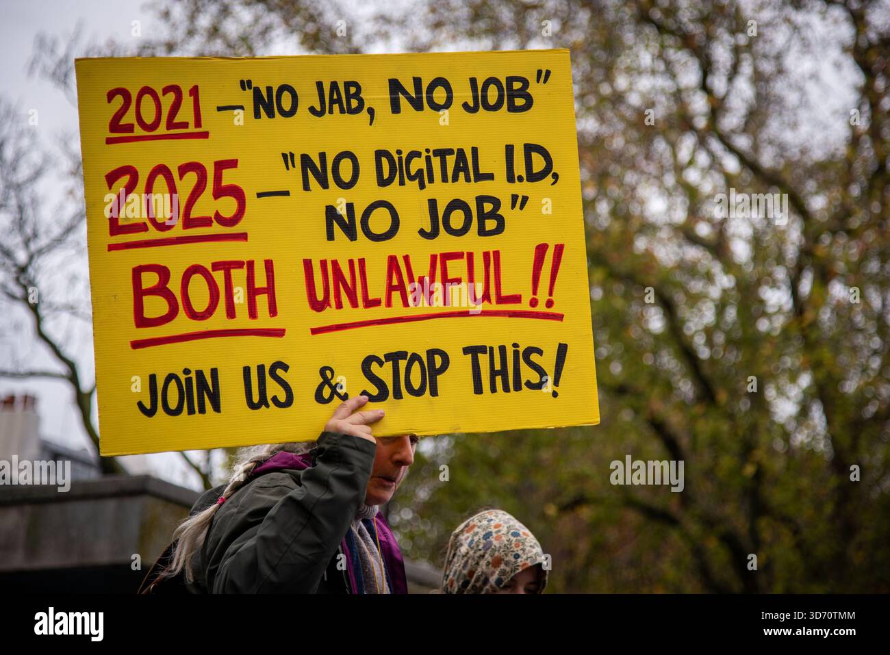 A protestor holds a placard during the Unite Against Digital ID Protest ...