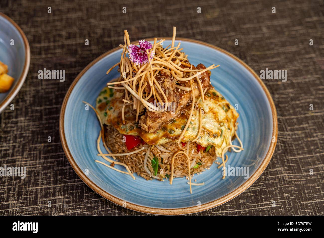 Peruvian arroz chaufa served with chijaukay chicken and egg omelet ...