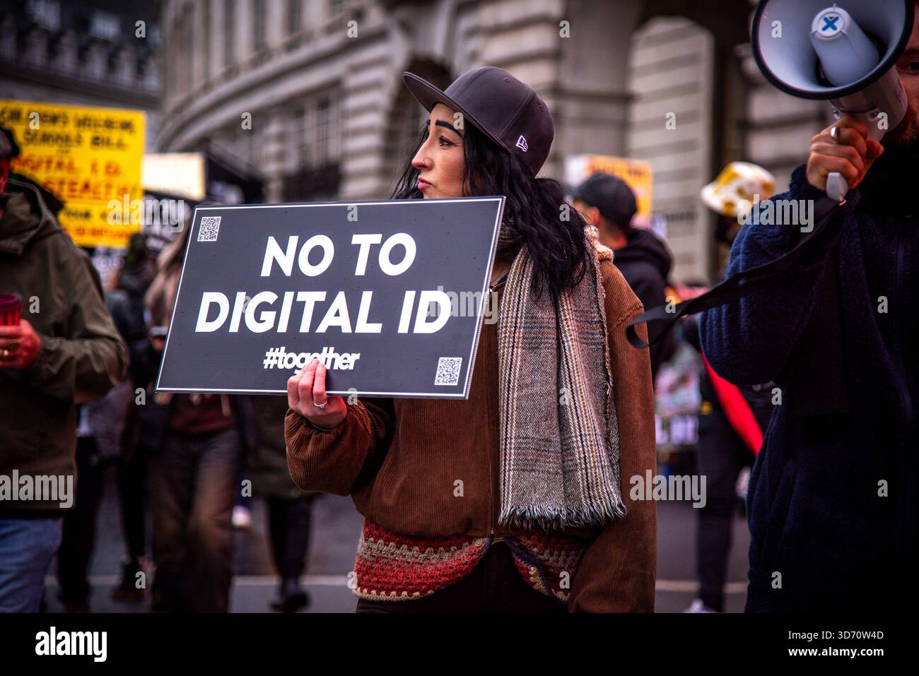 A protestor holds a placard during the Unite Against Digital ID Protest ...