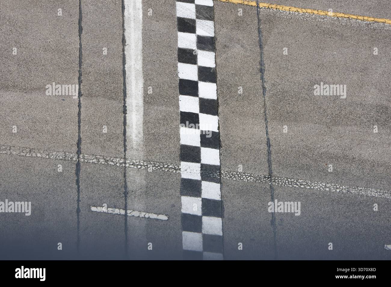 Checkered finish line on an asphalt racetrack for competitive race ...