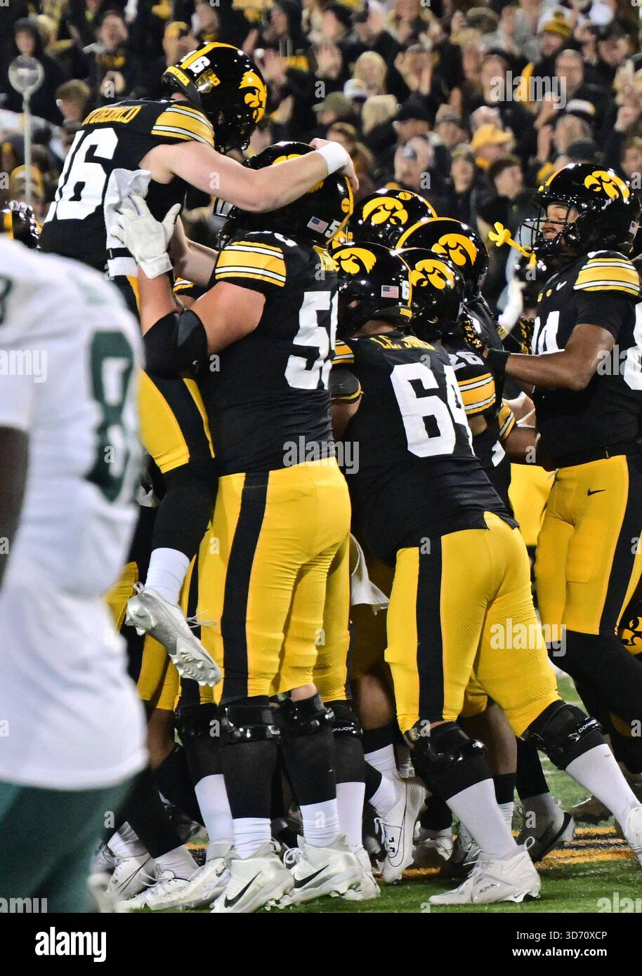 IOWA CITY, IA - NOVEMBER 22: Iowa players surround Iowa placekicker ...