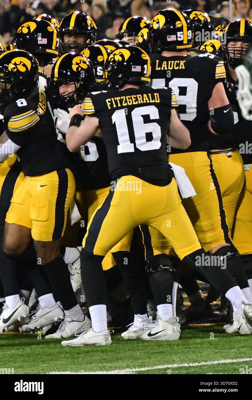 IOWA CITY, IA - NOVEMBER 22: Iowa players surround Iowa placekicker ...