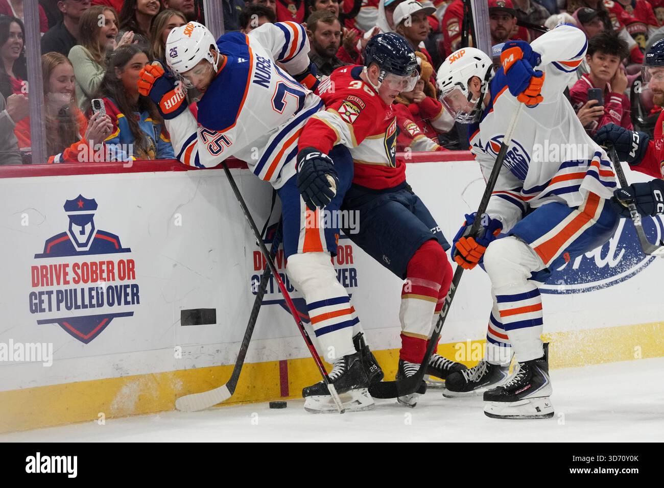 Florida Panthers right wing Jack Devine, center, goe for the puck ...