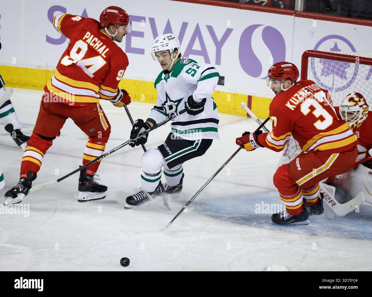 Dallas Stars' Wyatt Johnston, centre, chases a loose puck as Calgary ...