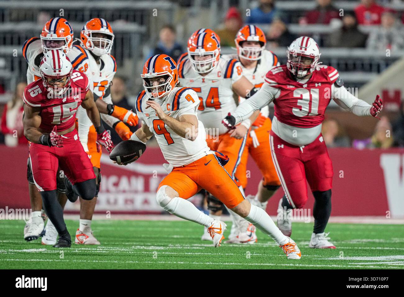 Illinois quarterback Luke Altmyer (9) runs against Wisconsin linebacker ...