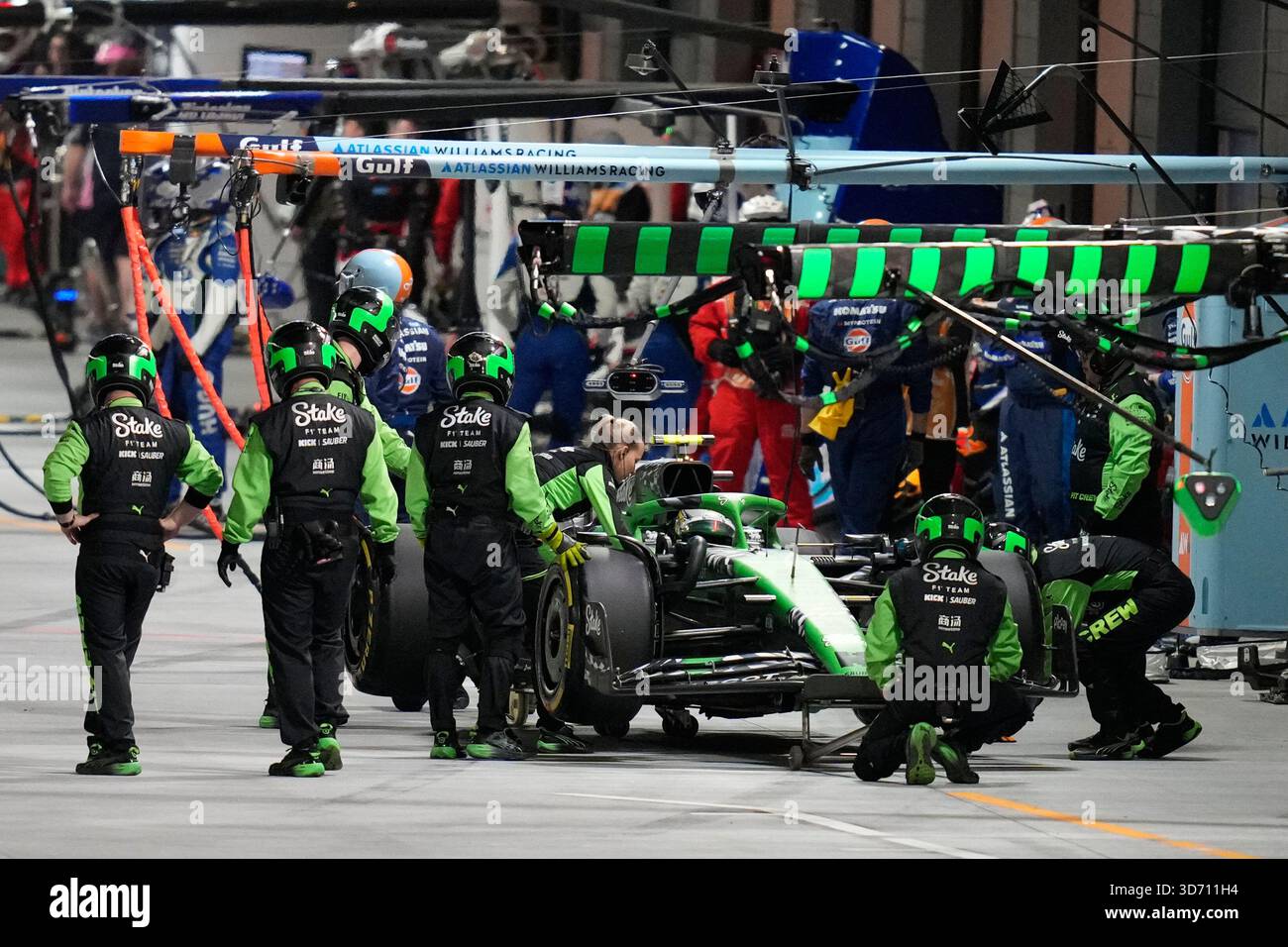 Crews work on the car of Kick Sauber driver Gabriel Bortoleto of Brazil ...